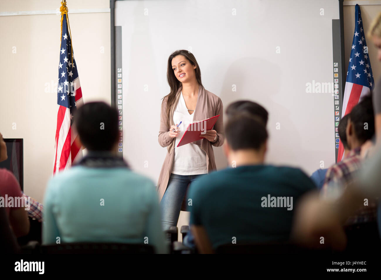 Young beautiful teacher gives lecture to students in classroom Stock ...