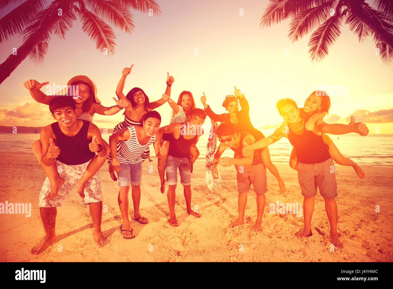 Group of young people having fun on the beach hi-res stock photography ...