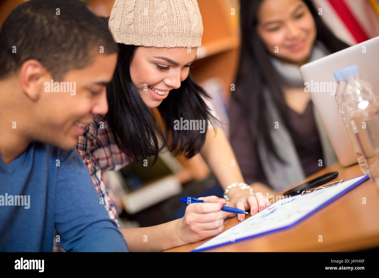 Classmates writing her task after class Stock Photo - Alamy