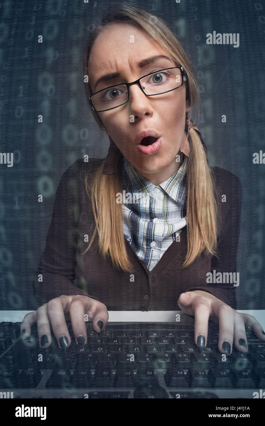 disappointed woman typing on a keyboard in front of a computer screen ...