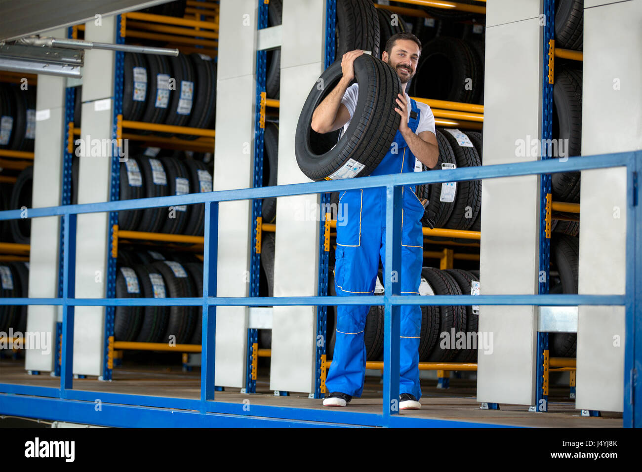 Mechanic carrying vehicle tire hi-res stock photography and images - Alamy