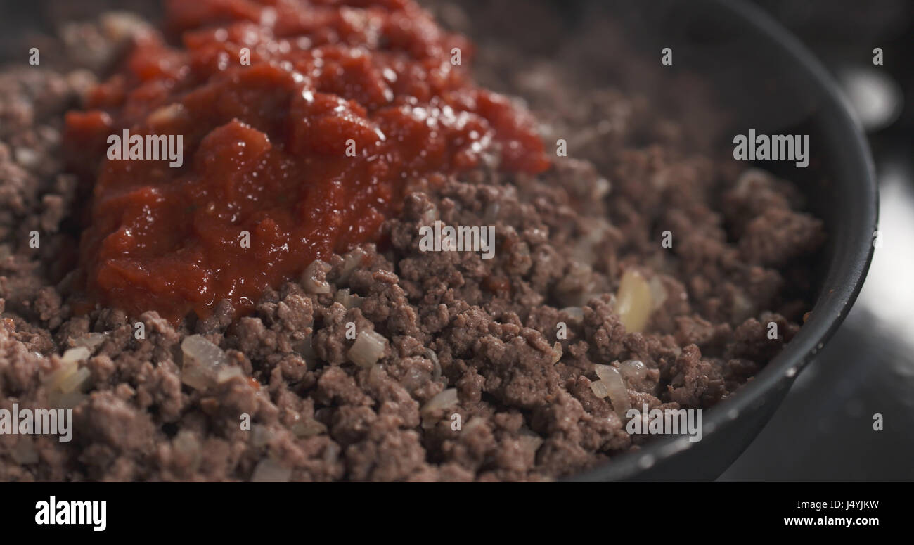 roasting minced beef with tomato paste in a pan Stock Photo - Alamy