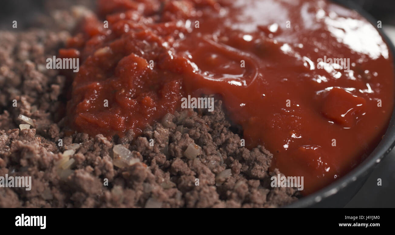 roasting minced beef with tomato paste in a pan Stock Photo - Alamy