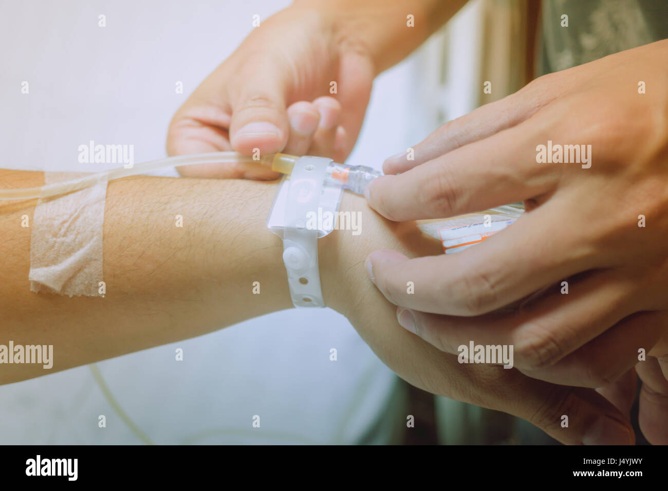 Close up hand adjust saline IV drip for patient in hospital Stock Photo ...