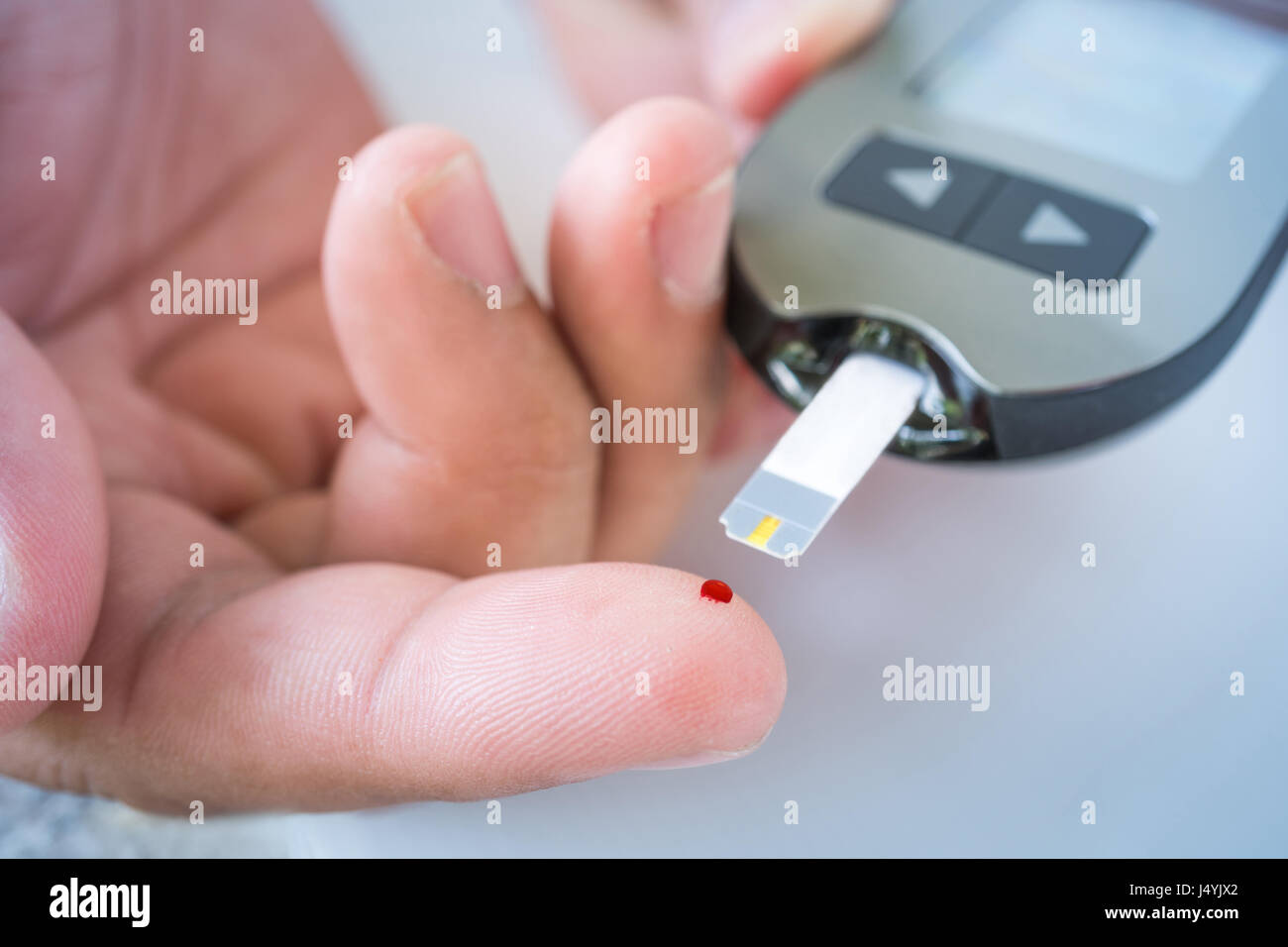 Close up of male finger with blood drop and glucometer test strip Stock ...