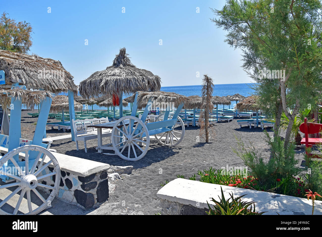 Wagon style chairs and tables on Perissa Beach Santorini Cyclades Greek ...