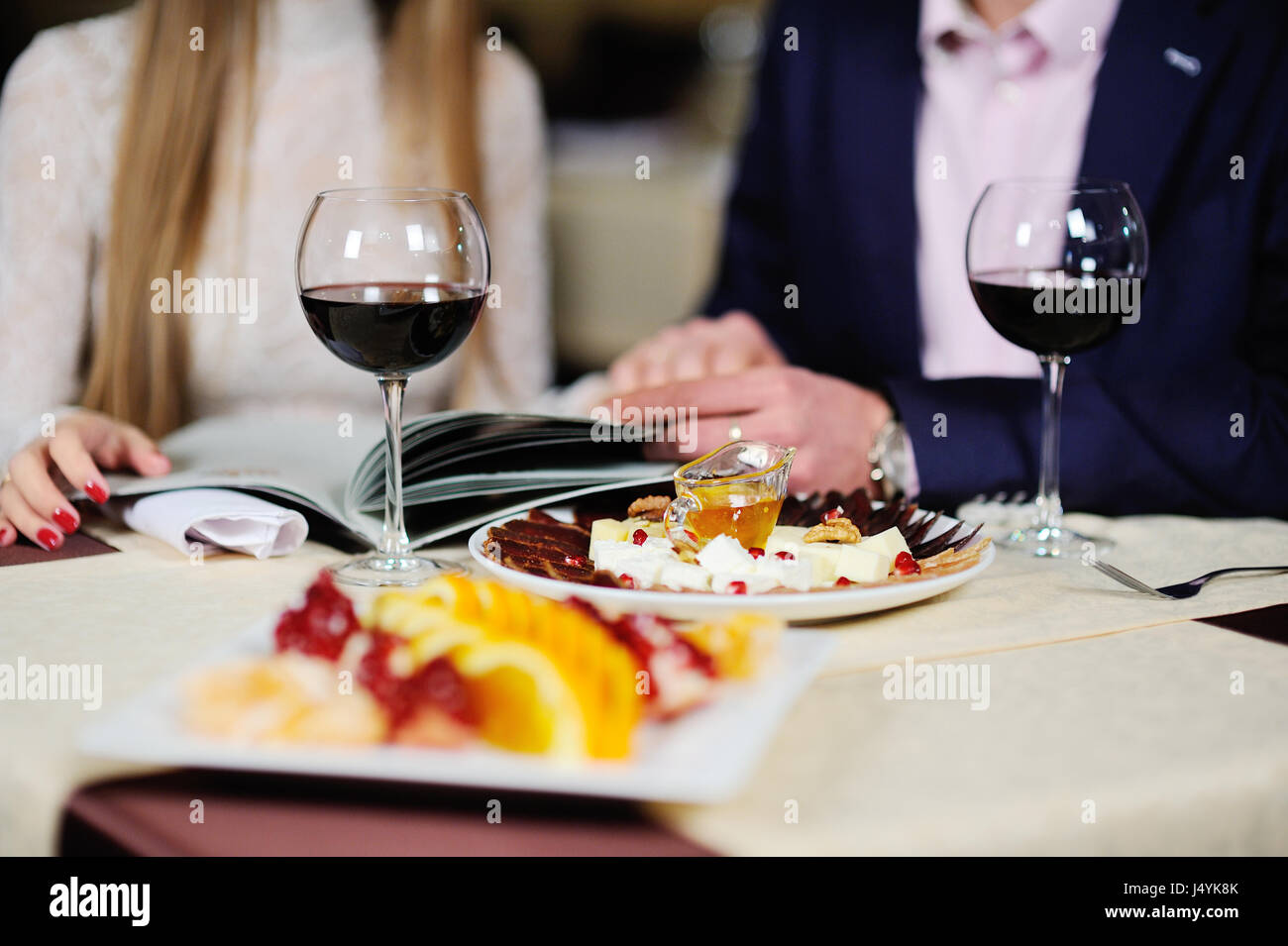 guy with a girl in a restaurant choose dishes from the menu Stock Photo ...