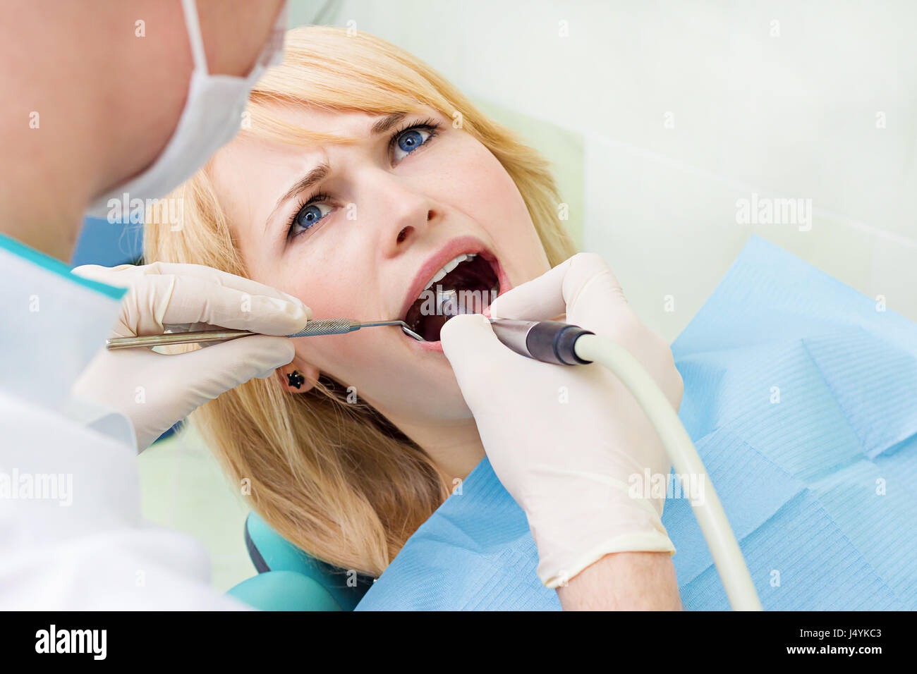 Closeup portrait young female, woman, patient sitting in dentist chair ...