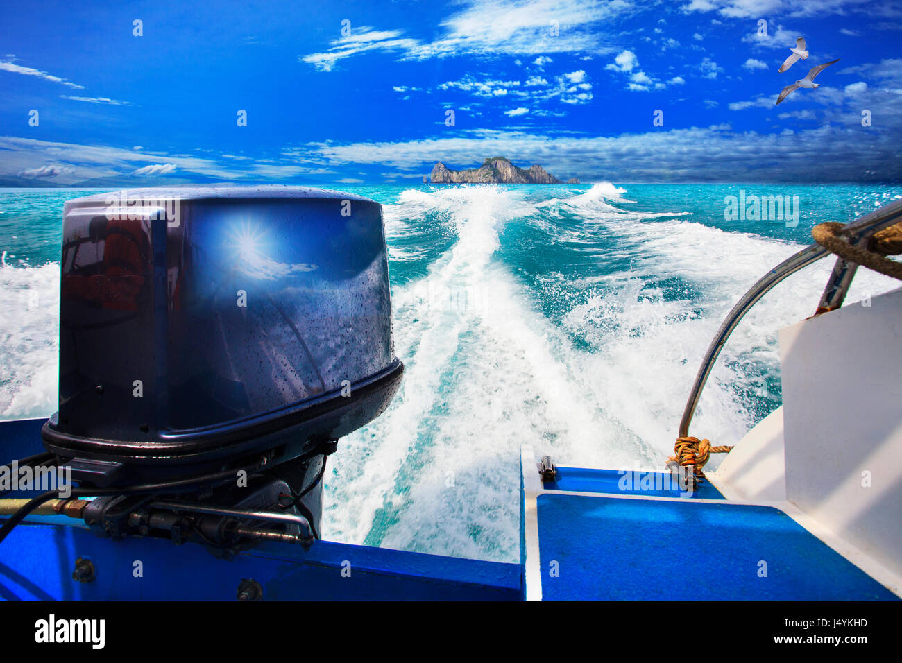 rear view from speed boats running against clear sea blue water ...
