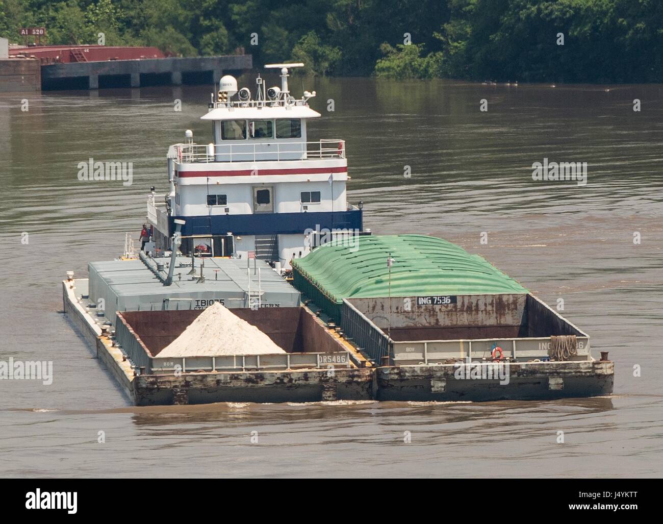 A tug boat pushes a barge at the Consolidated Grain and Barge ...