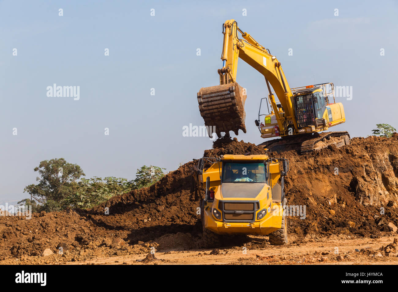 Construction industrial earthworks grader machine loading earth into ...