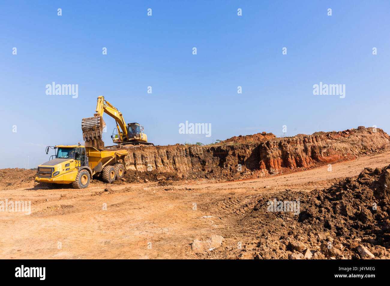Construction industrial earthworks grader machine loading earth into ...