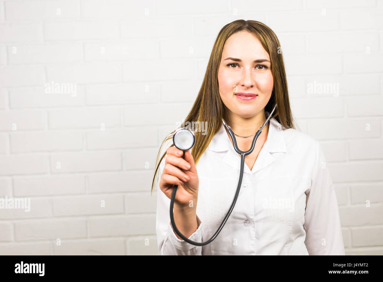 Woman doctor using stethoscope Stock Photo - Alamy