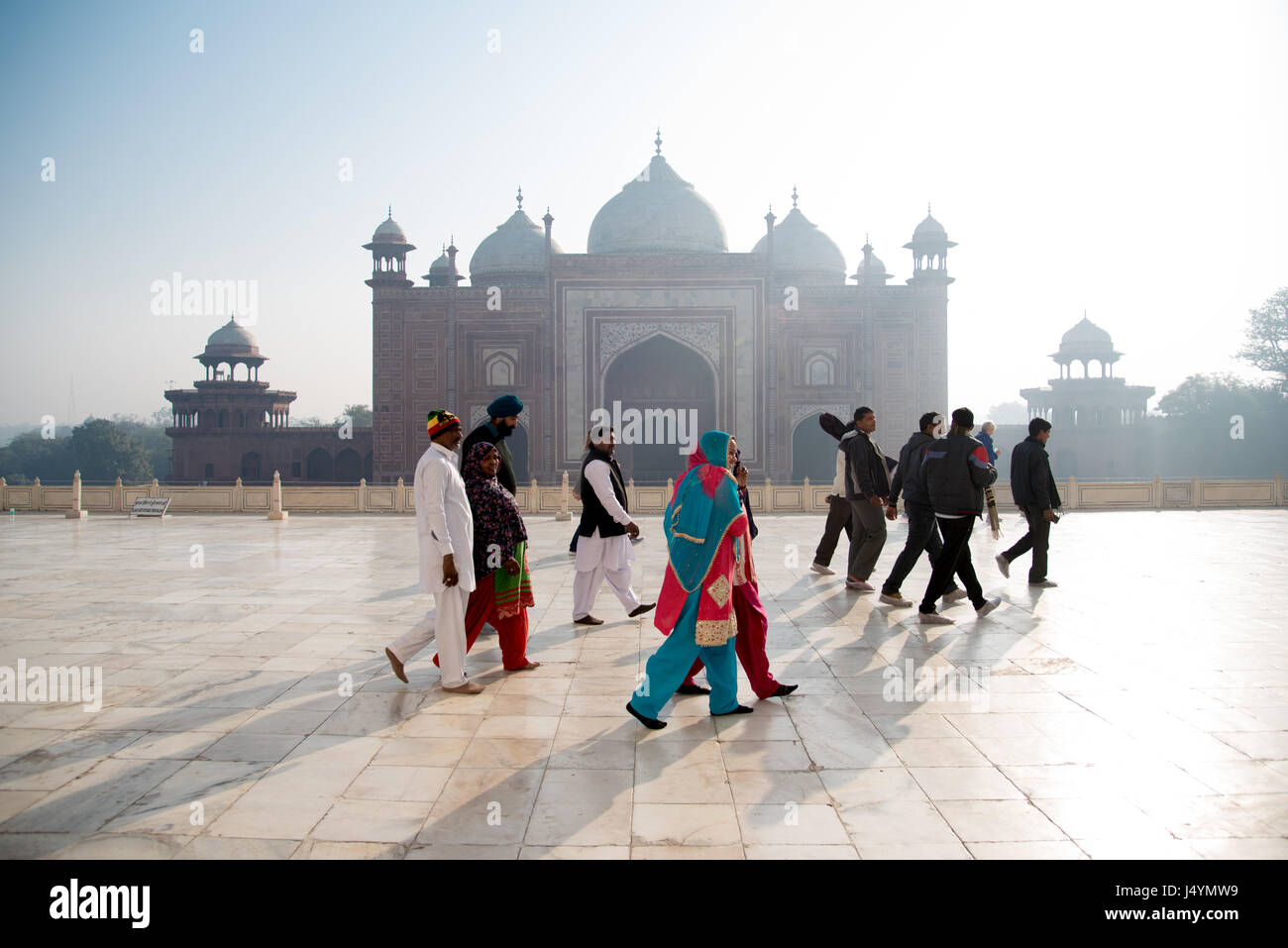 Group of Tourists in colourful clothing at Taj Mahal complex in Agra ...
