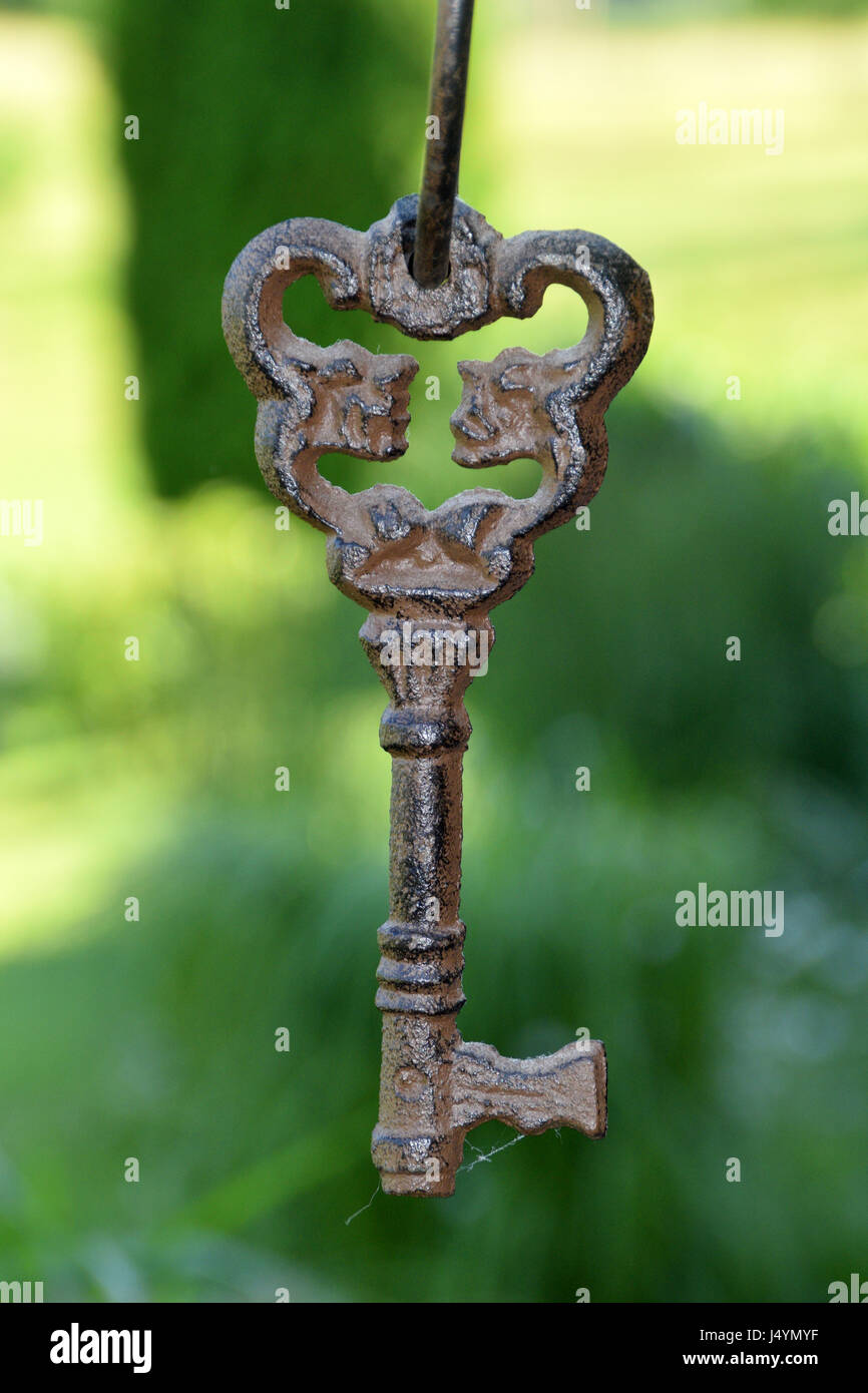 Ancient key on green background Stock Photo - Alamy