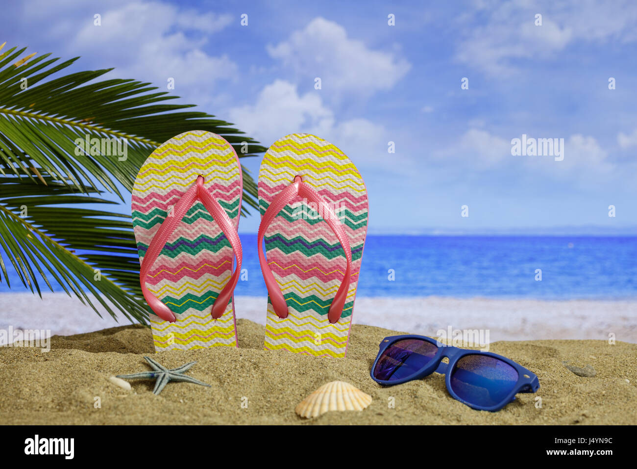 Summer vacations - Flip flops on a sandy beach Stock Photo - Alamy