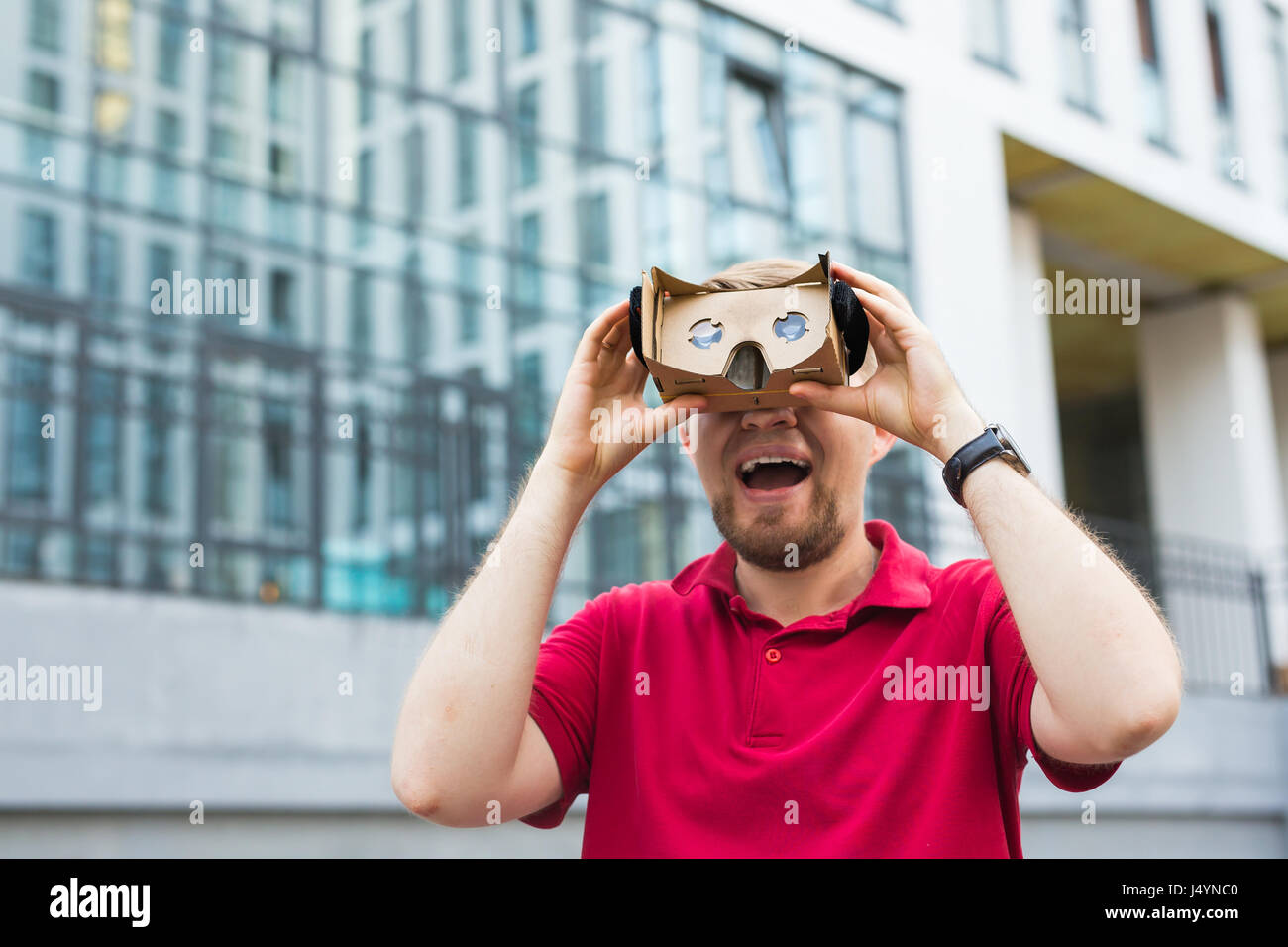 Funny man using cardboard virtual reality goggle outdoors Stock Photo ...