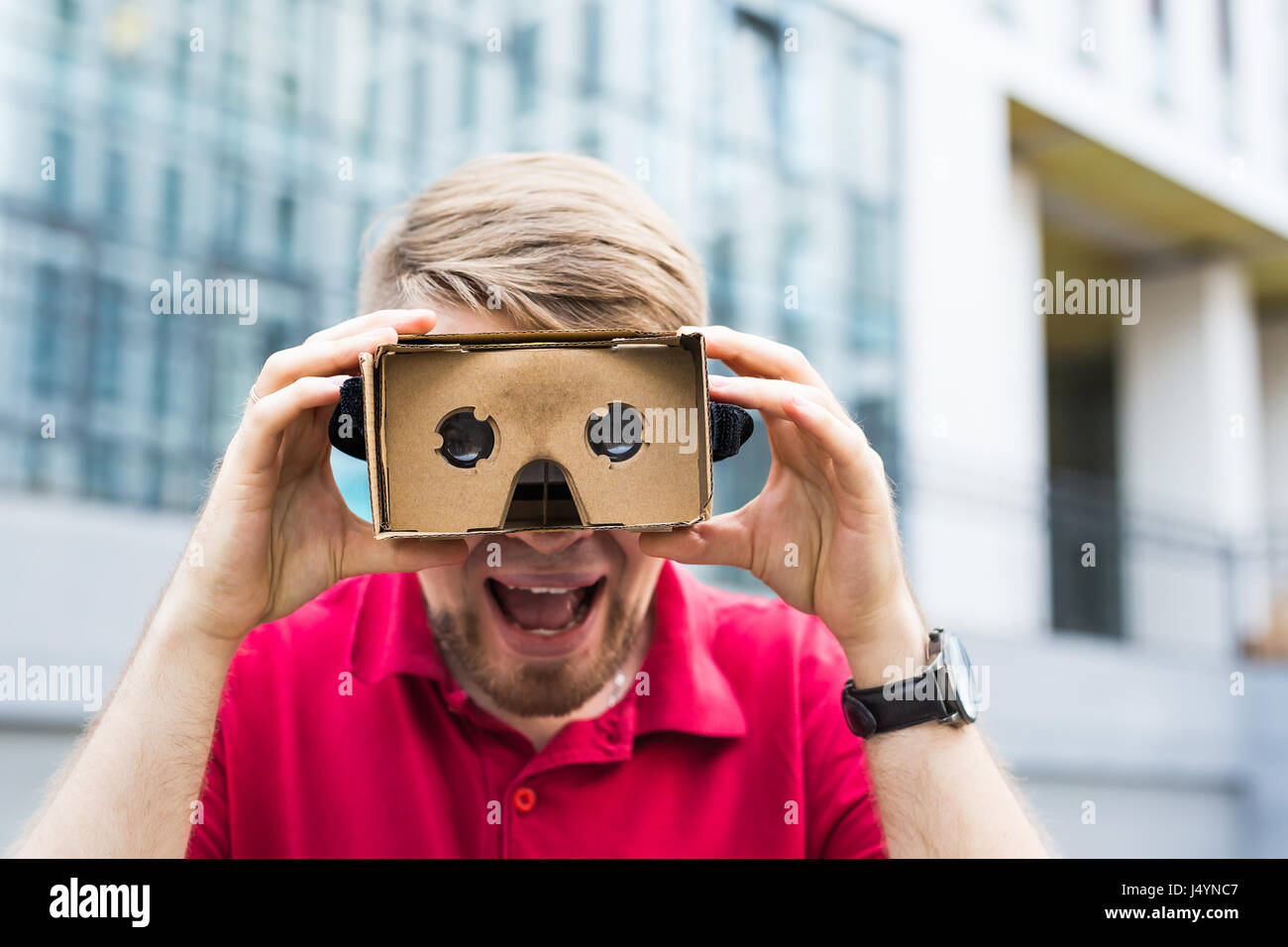 Funny man using cardboard virtual reality goggle outdoors Stock Photo ...