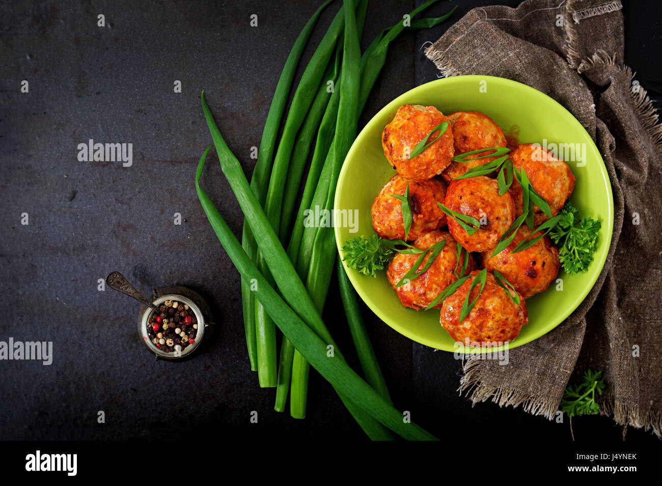 Baked meatballs of chicken fillet in tomato sauce. Flat lay. Top view ...