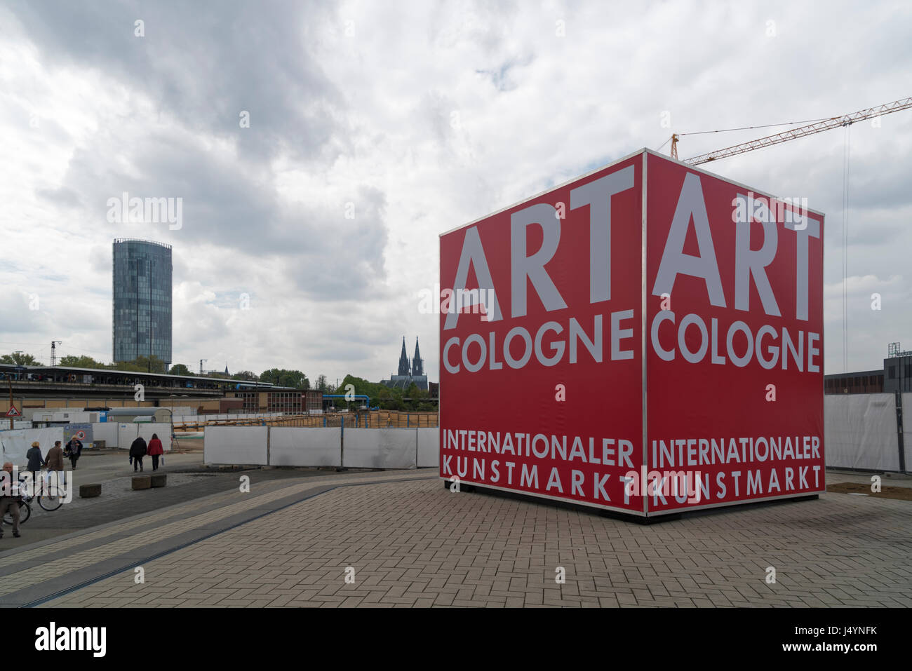 The red cube of Art Cologne in front of the skyline of Cologne, Germany ...