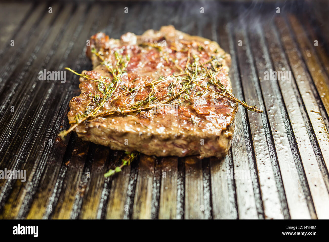 Grilled beef steak on the grill, close-up Stock Photo - Alamy