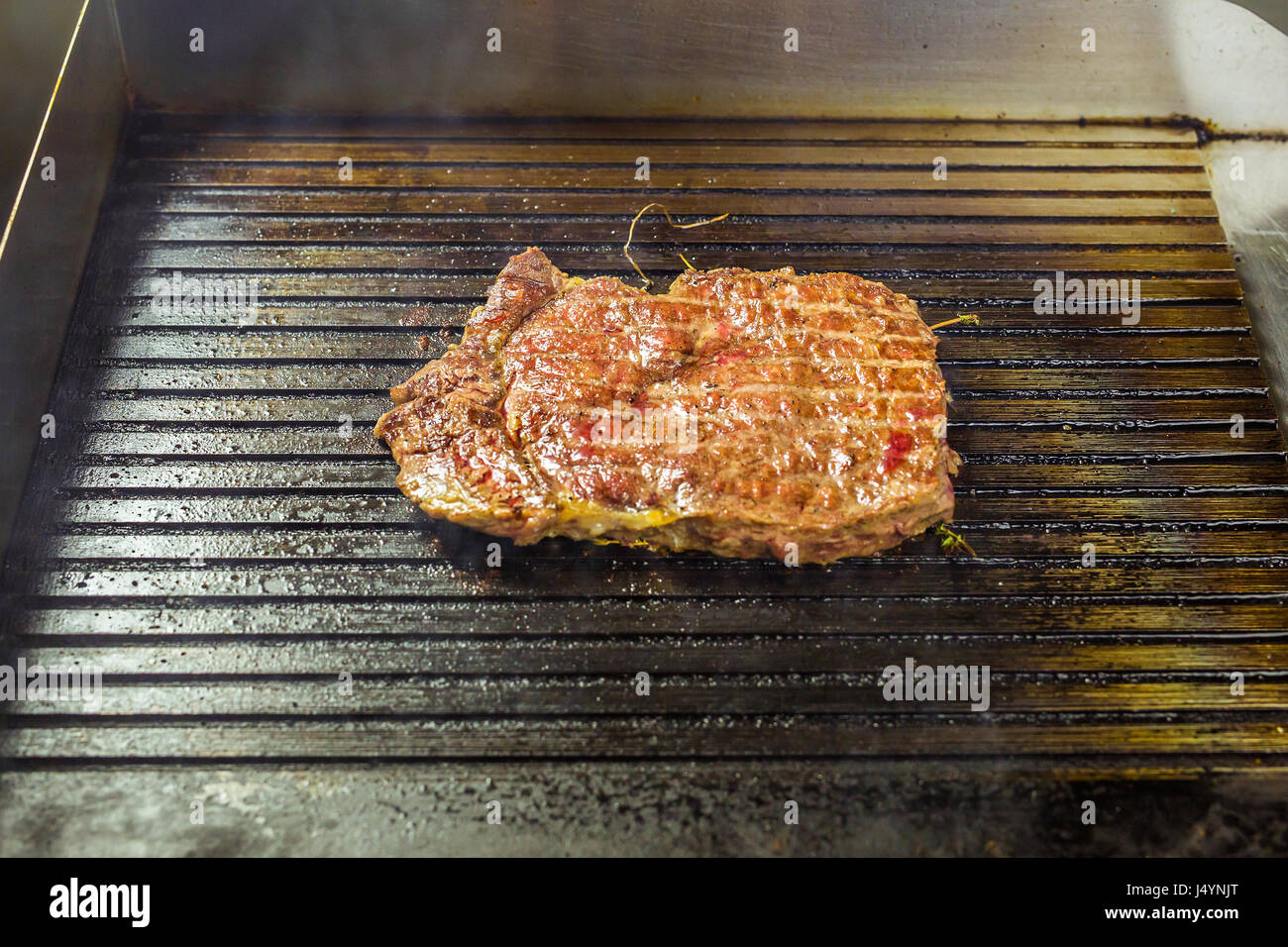 closeup of a steak on grill Stock Photo - Alamy