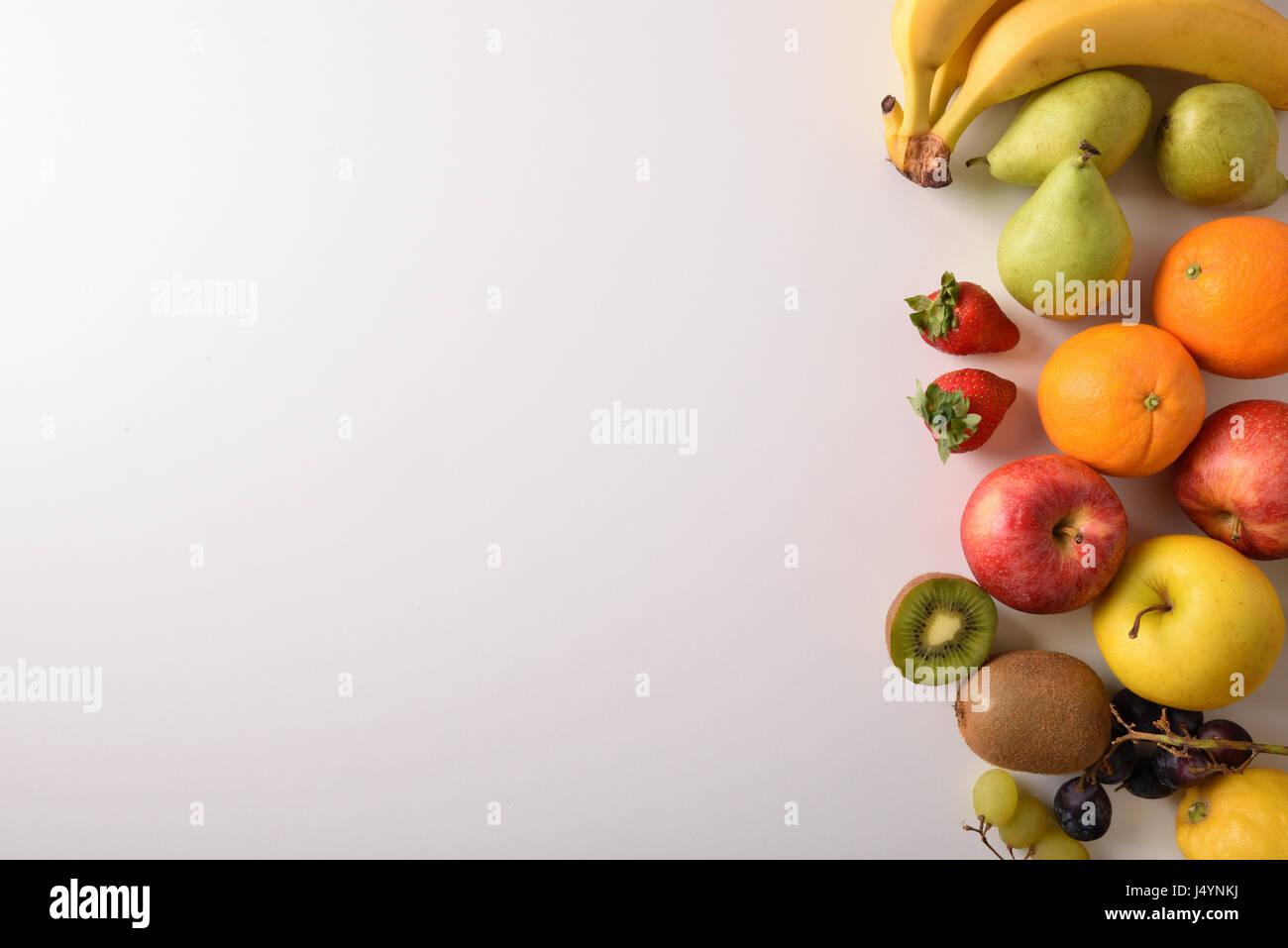 Assortment of fruits on a white table. Horizontal composition. Top view ...