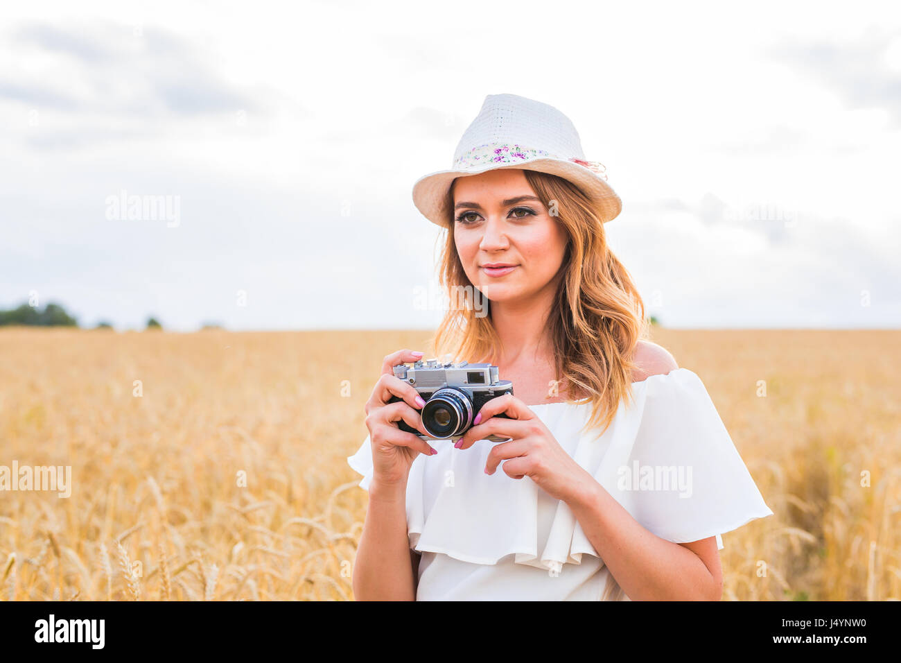 female photographer in the field with a camera taking pictures Stock ...