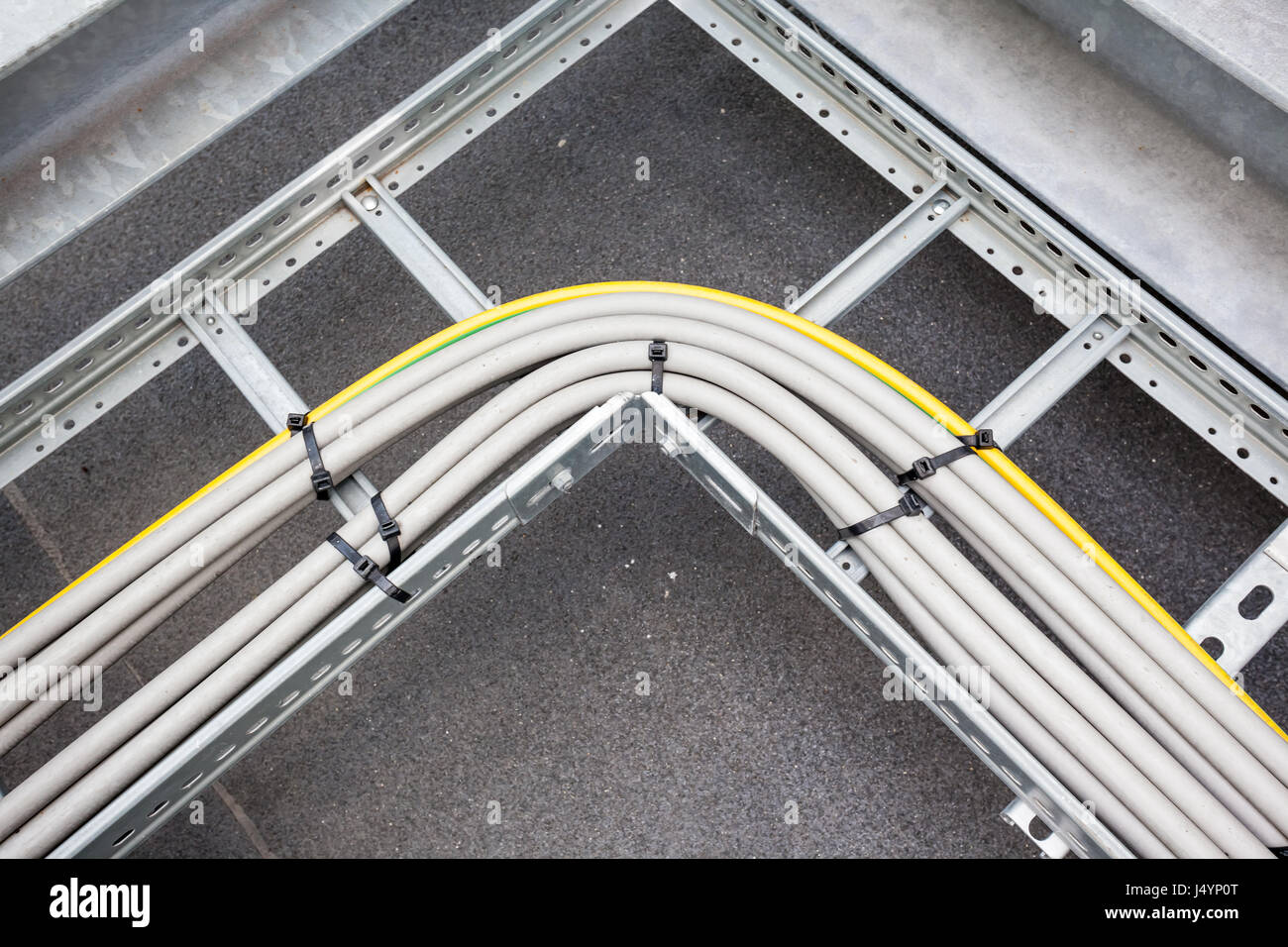 Electrical cables are located in a cableway on the roof of a building ...