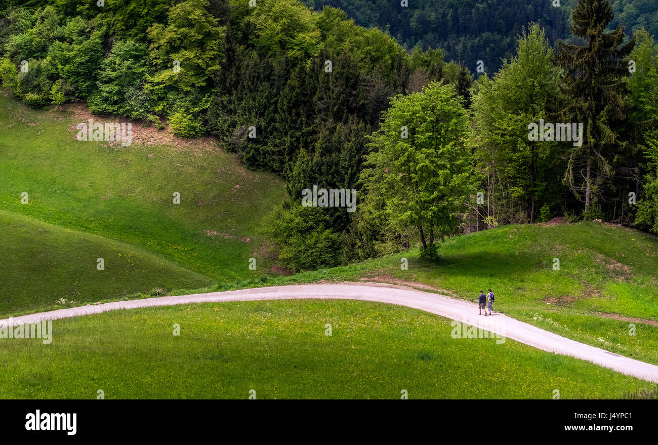 Landscape with family walking in the hills Stock Photo - Alamy