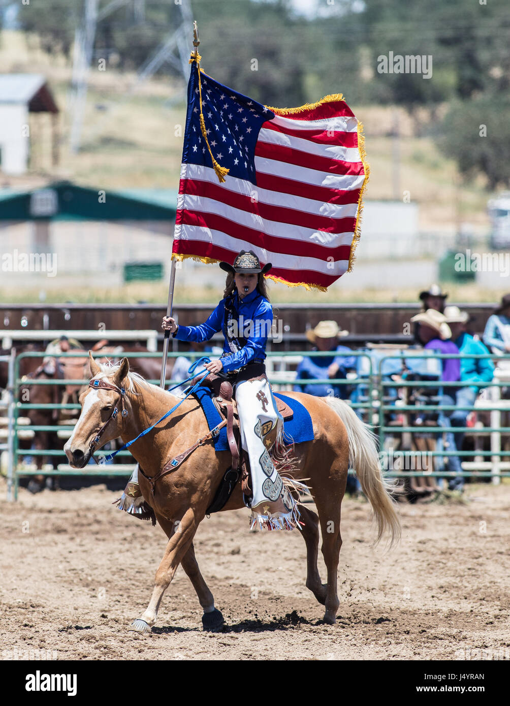 Drill team cowgirl rides in the arena at the Cottonwood Rodeo in ...