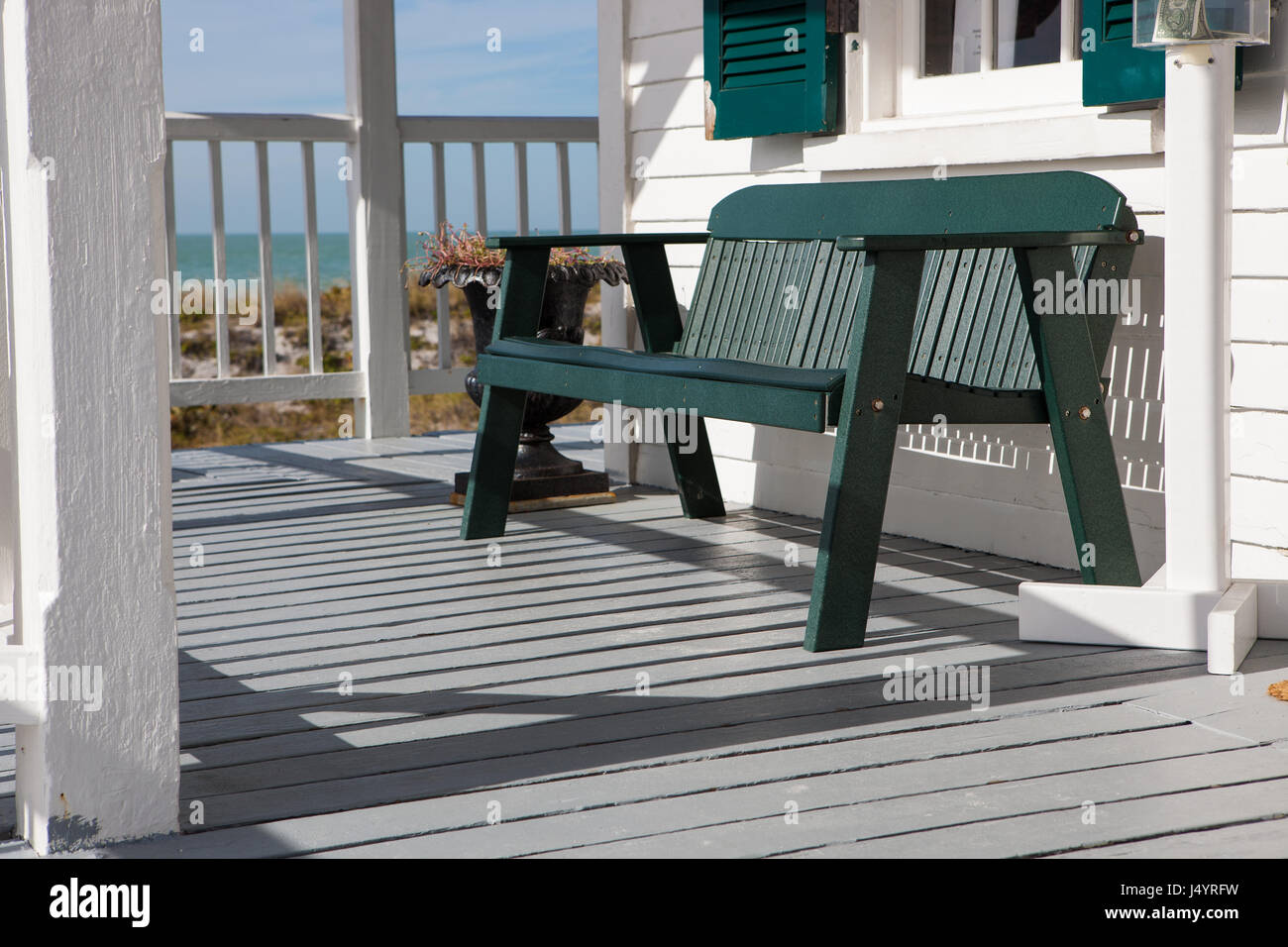 Porch with green bench of Florida style building Stock Photo - Alamy