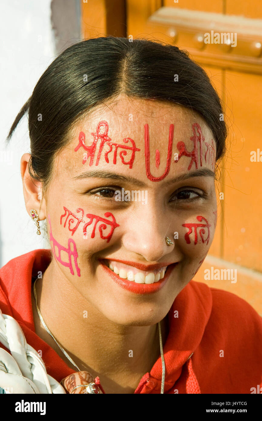 Devotee writing radhe krishna on face by sandalwood paste, uttar ...