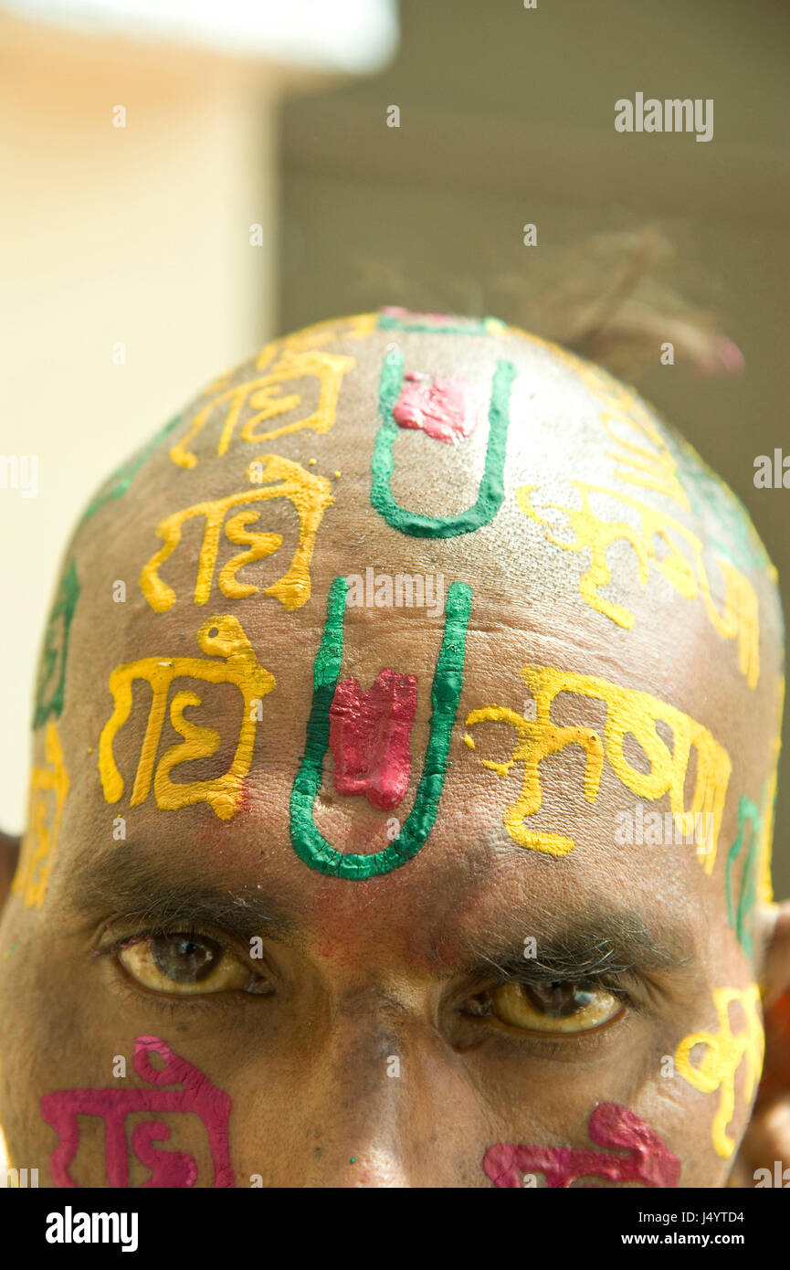 Devotee writing radhe krishna on head by sandalwood paste, uttar ...