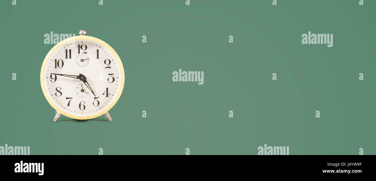 retro alarm clock header on colored background Stock Photo - Alamy