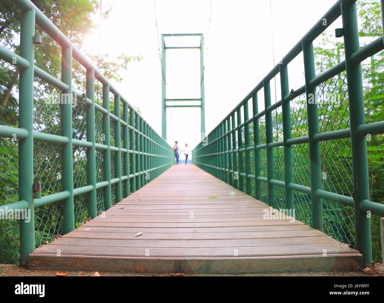 Rope bridge wood floor, Sweetheart on the steel bridge with blurred ...