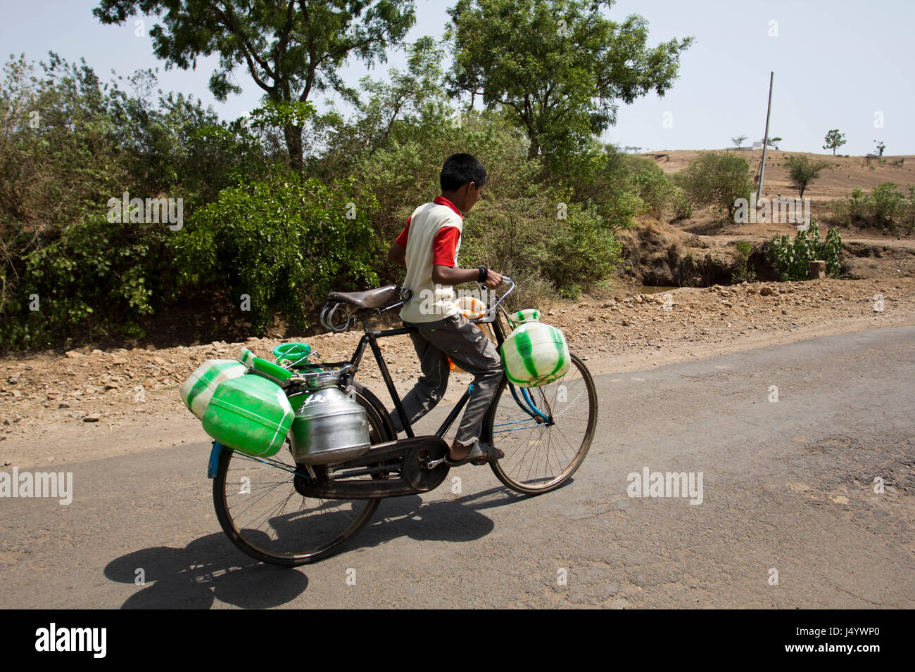 Boy carrying water pot on cycle, karnataka, india, asia Stock Photo - Alamy