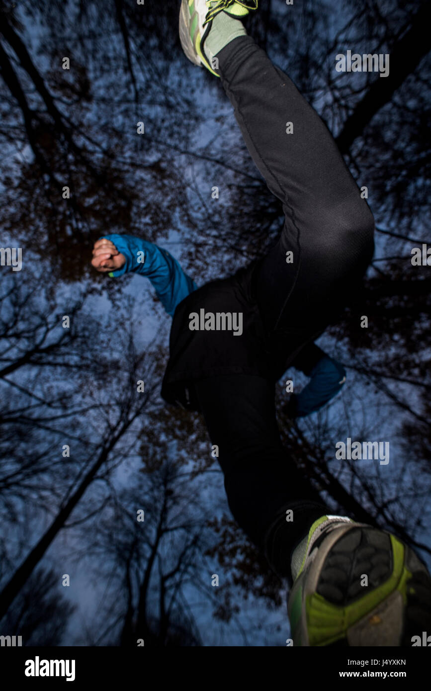 Low angle view of an adult man running in a forest trail in Jelenia ...