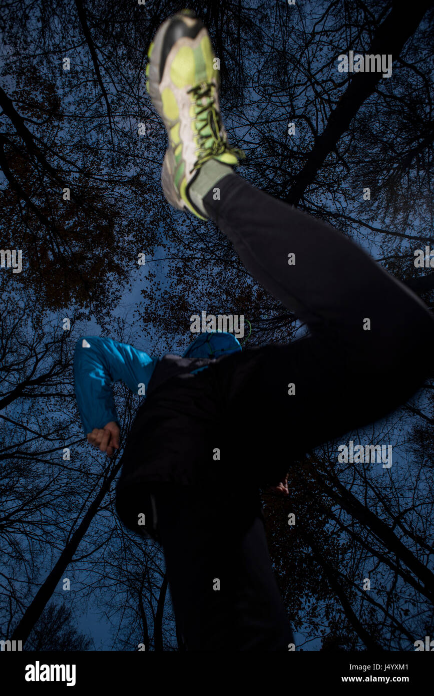 Low angle view of an adult man running in a forest trail in Jelenia ...