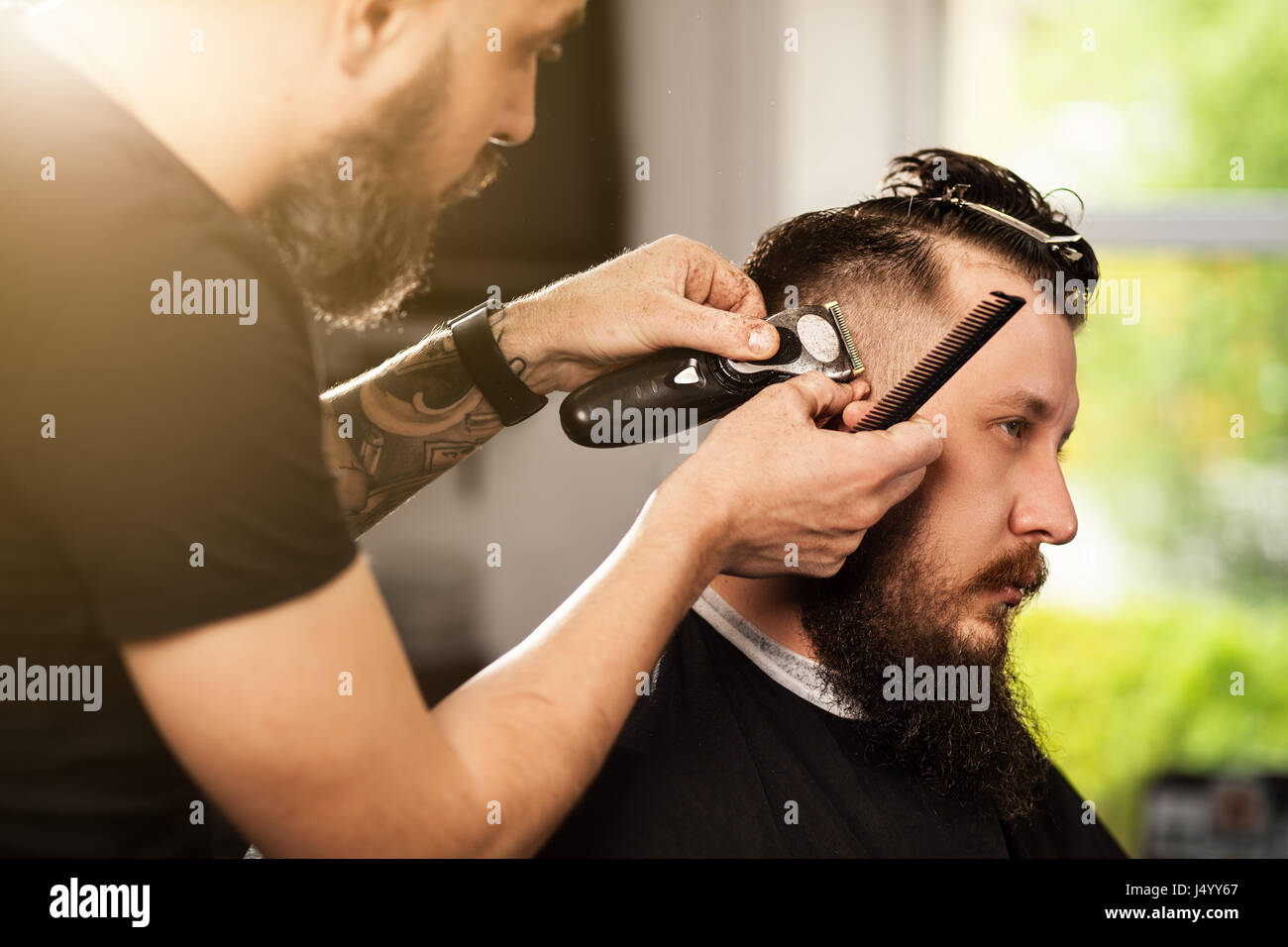 Professional barber in a barbershop doing a haircut Stock Photo - Alamy
