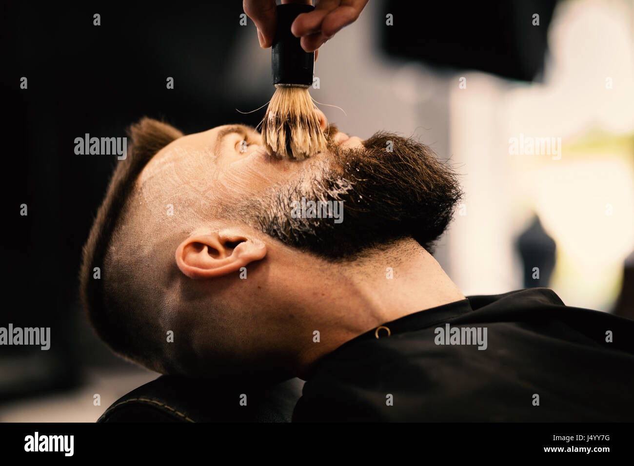 Professional barber in a barbershop doing a haircut Stock Photo - Alamy