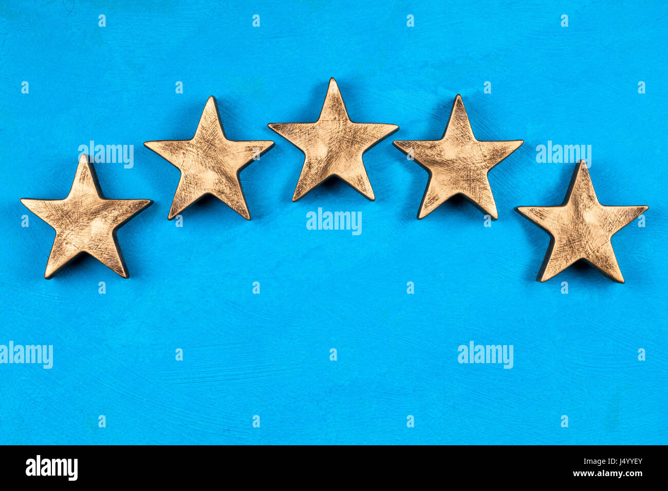 Five stars sign on blue background Stock Photo - Alamy
