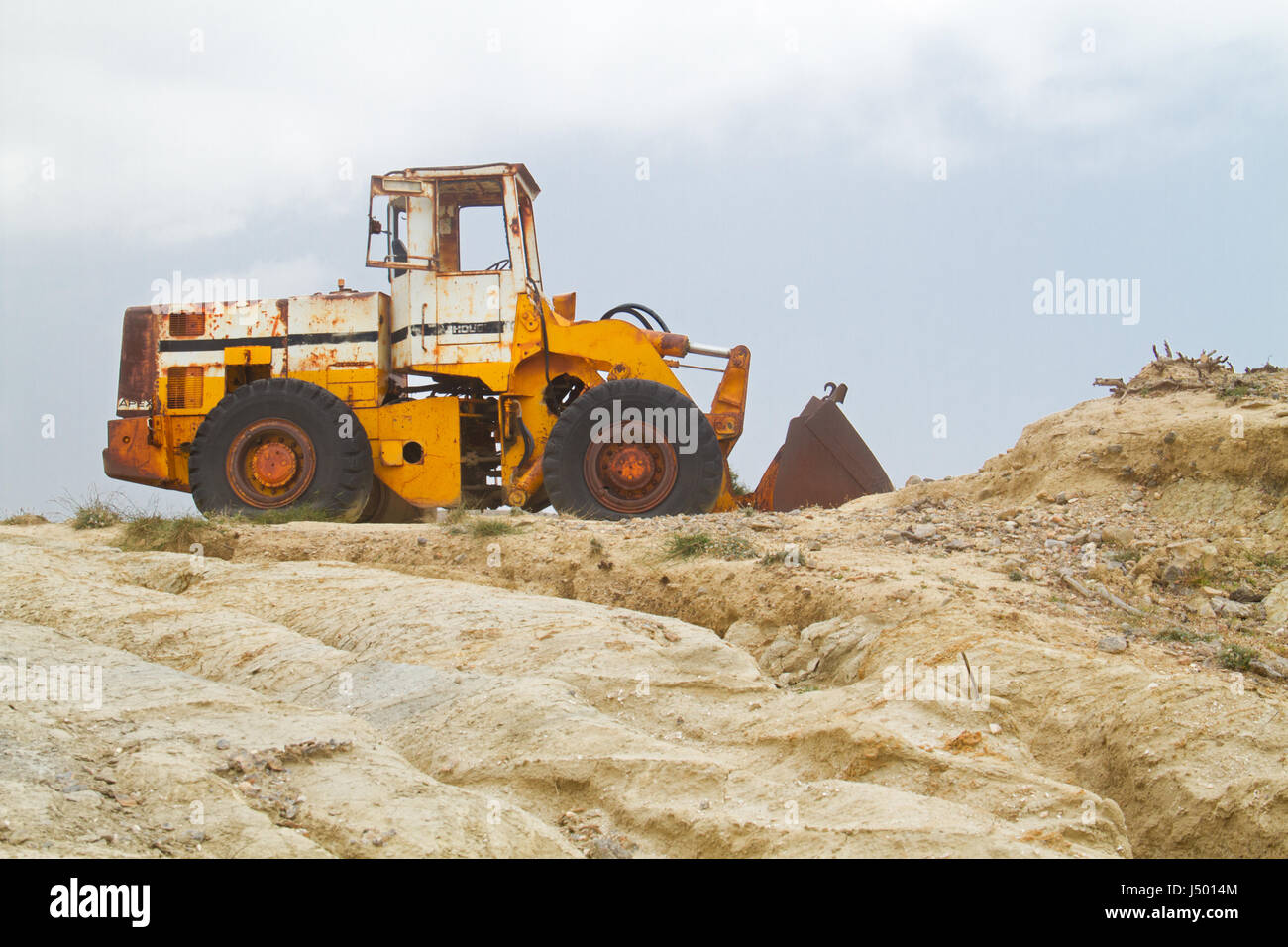 Old, rusty abandoned digger on top of a hill Stock Photo - Alamy