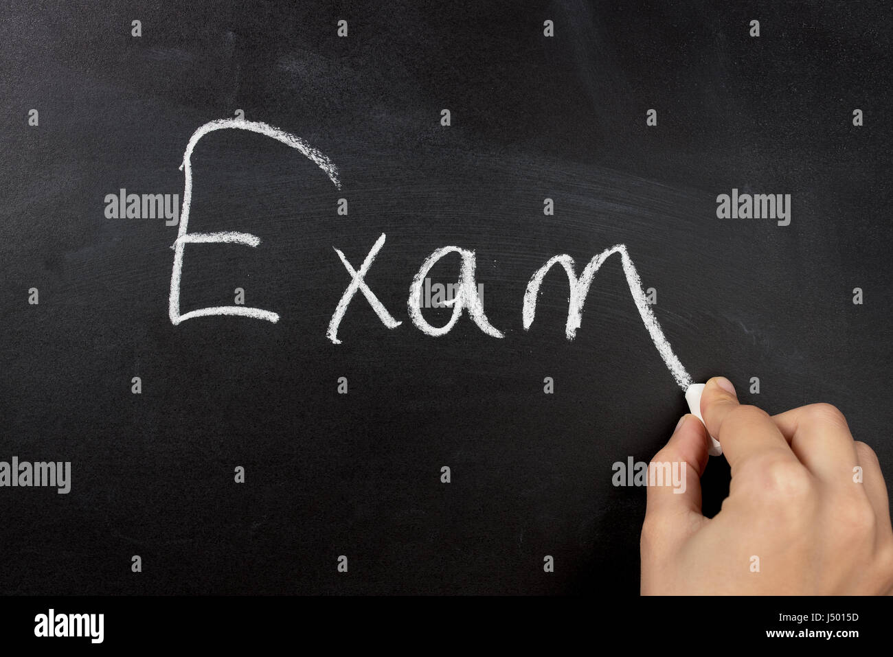 Woman hand with the chalkboard writing a word exam Stock Photo - Alamy