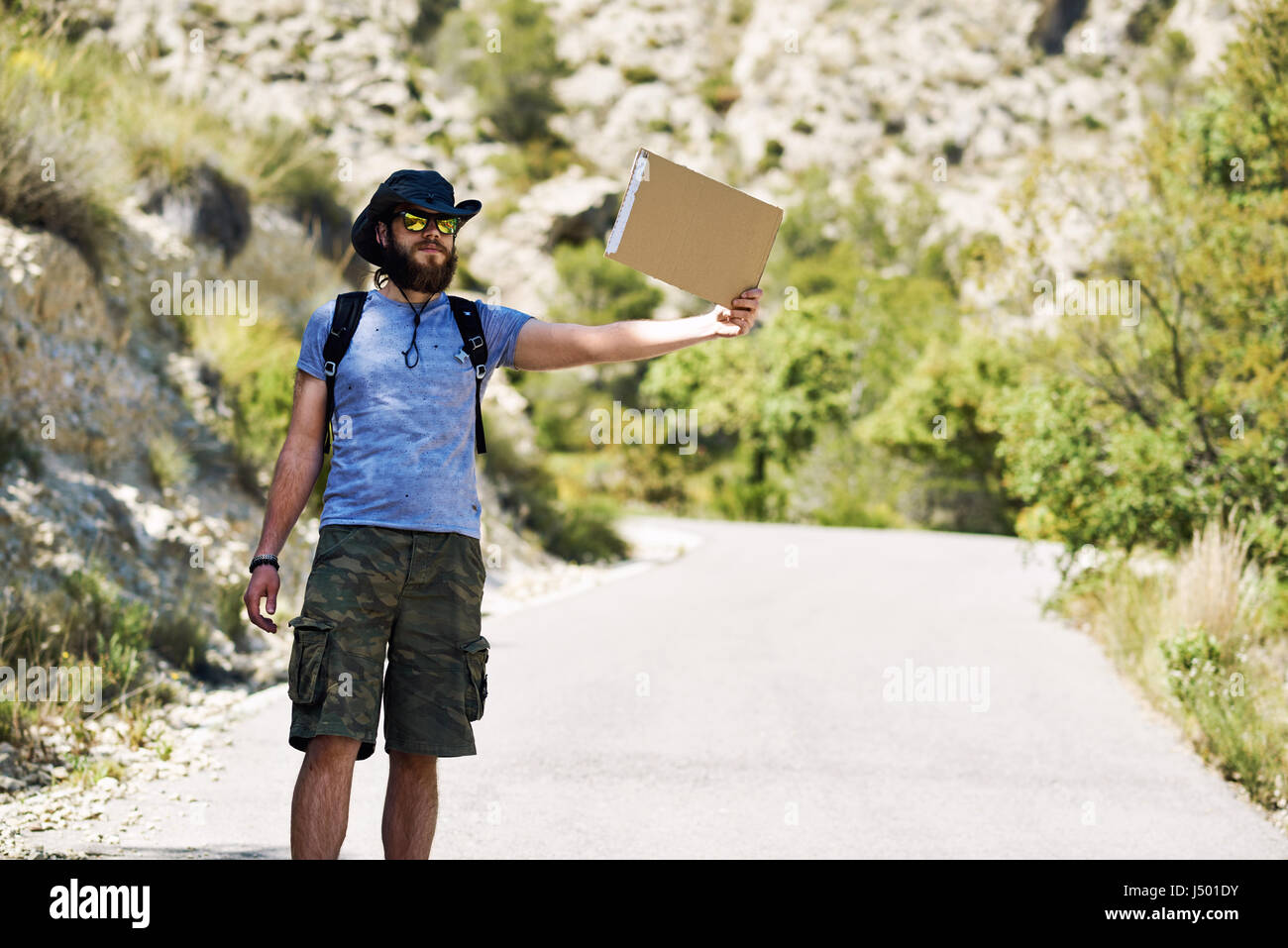 Young man hitchhiking on summer hi-res stock photography and images - Alamy