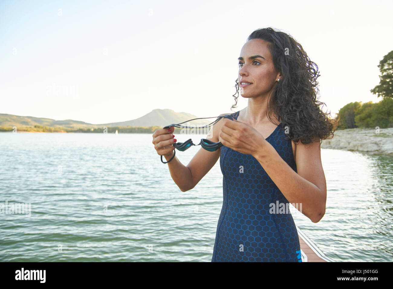 Female Triathlete at the edge of a lake Stock Photo - Alamy