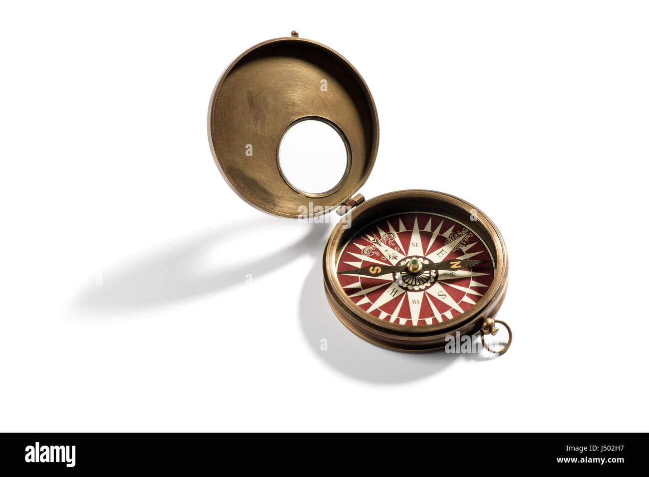 Old brass vintage compass for navigation opened to display the compass ...