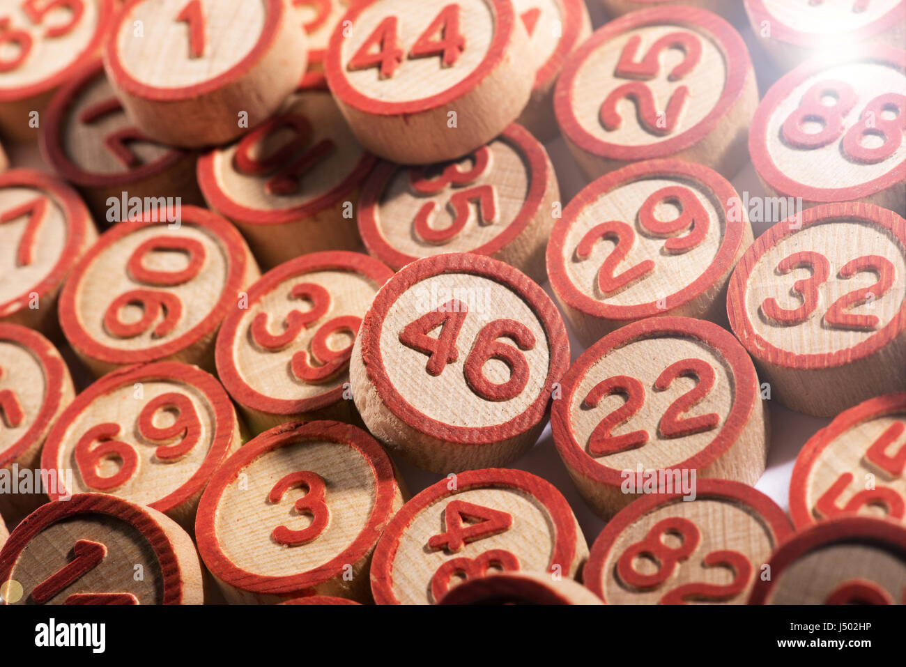 Round wooden bingo numbers with raised red numerals for a lucky win ...