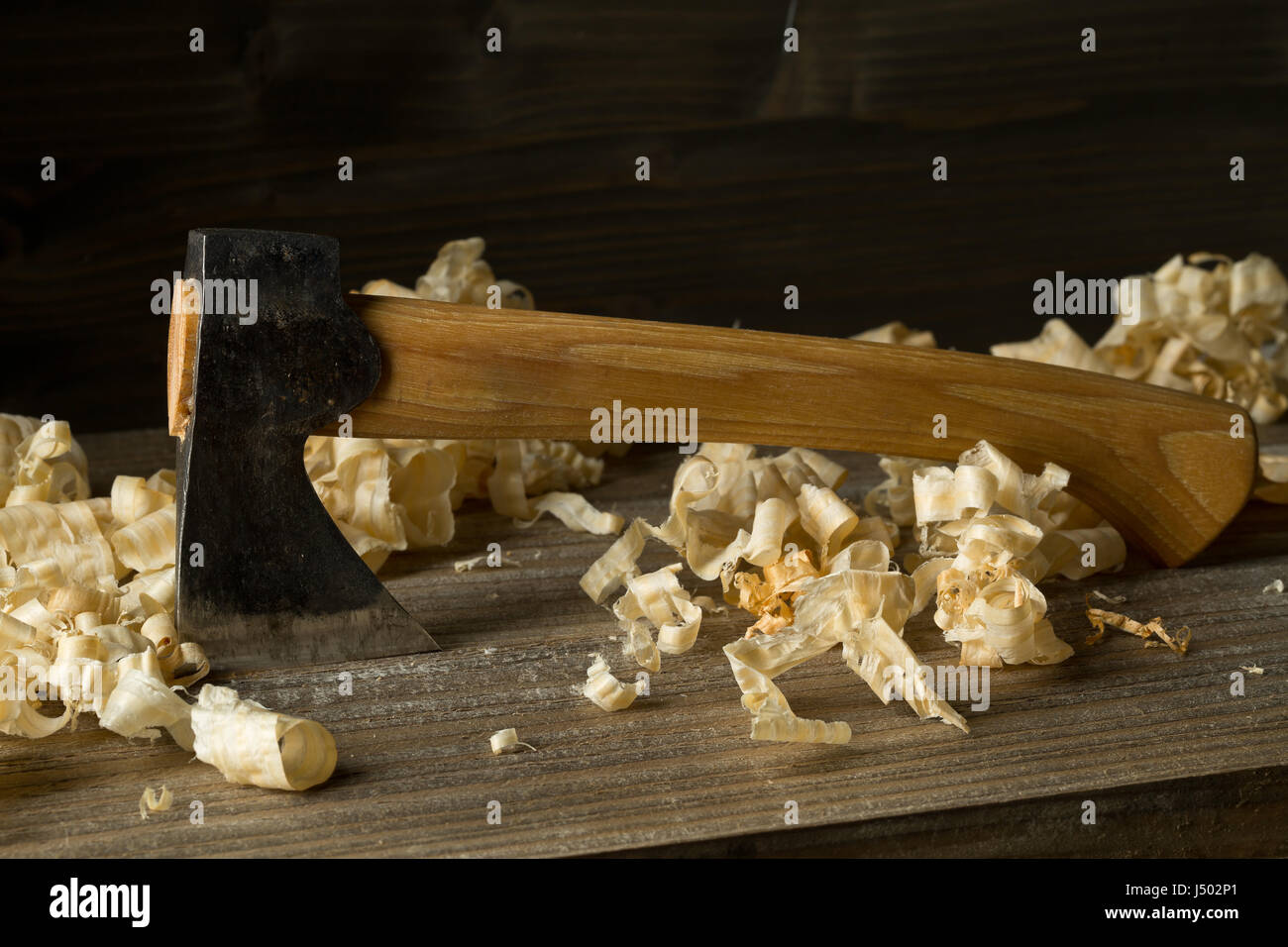 Woodworking carving axe tool on wooden boards in carpenter's workshop ...