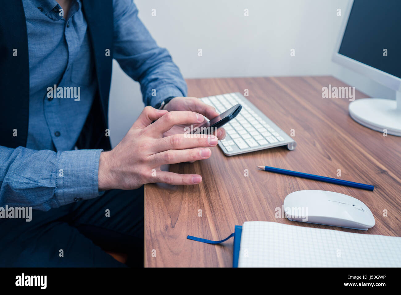 Seated man typing on hi-res stock photography and images - Alamy